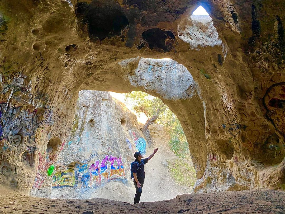 Hike To A Mesmerizing Sandstone Cave With Panoramic Views Of Santa ...
